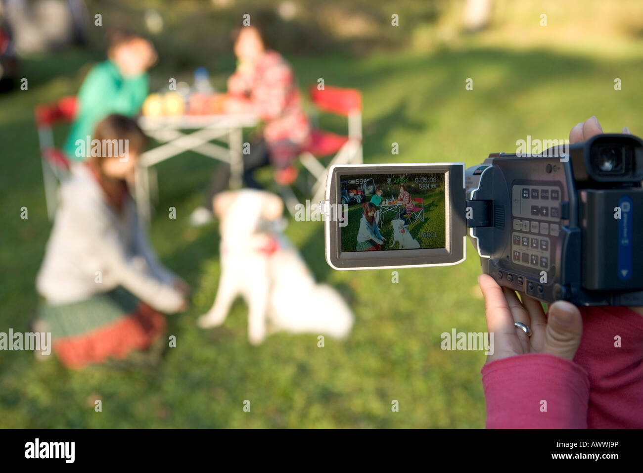 Teenage girl using home video camera, holding, filming Stock Photo - Alamy