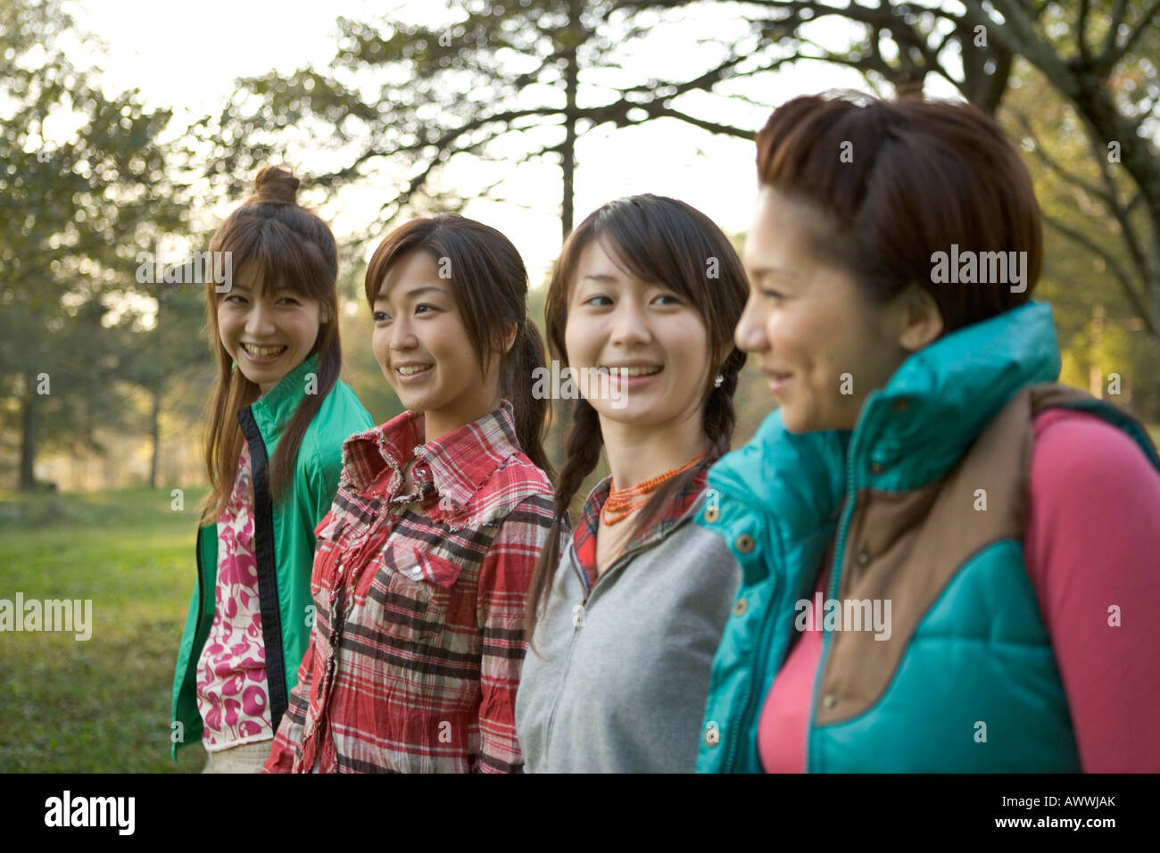Four teenage girls side by side, smiling Stock Photo - Alamy