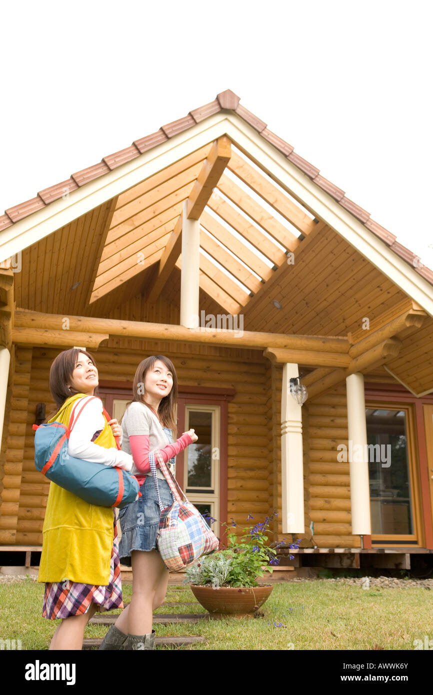 Two young women outside house Stock Photo - Alamy