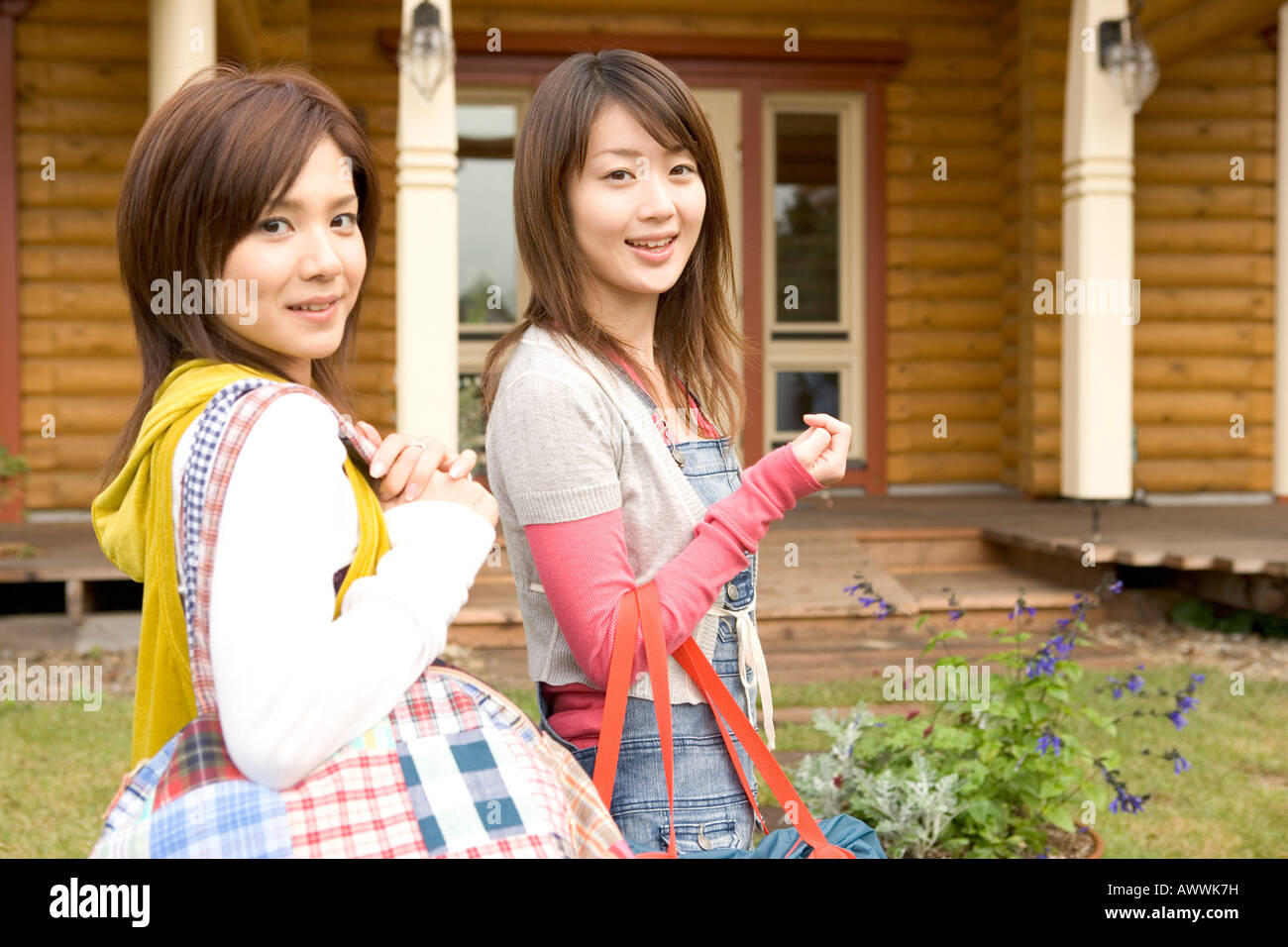 Two young women outside house Stock Photo - Alamy