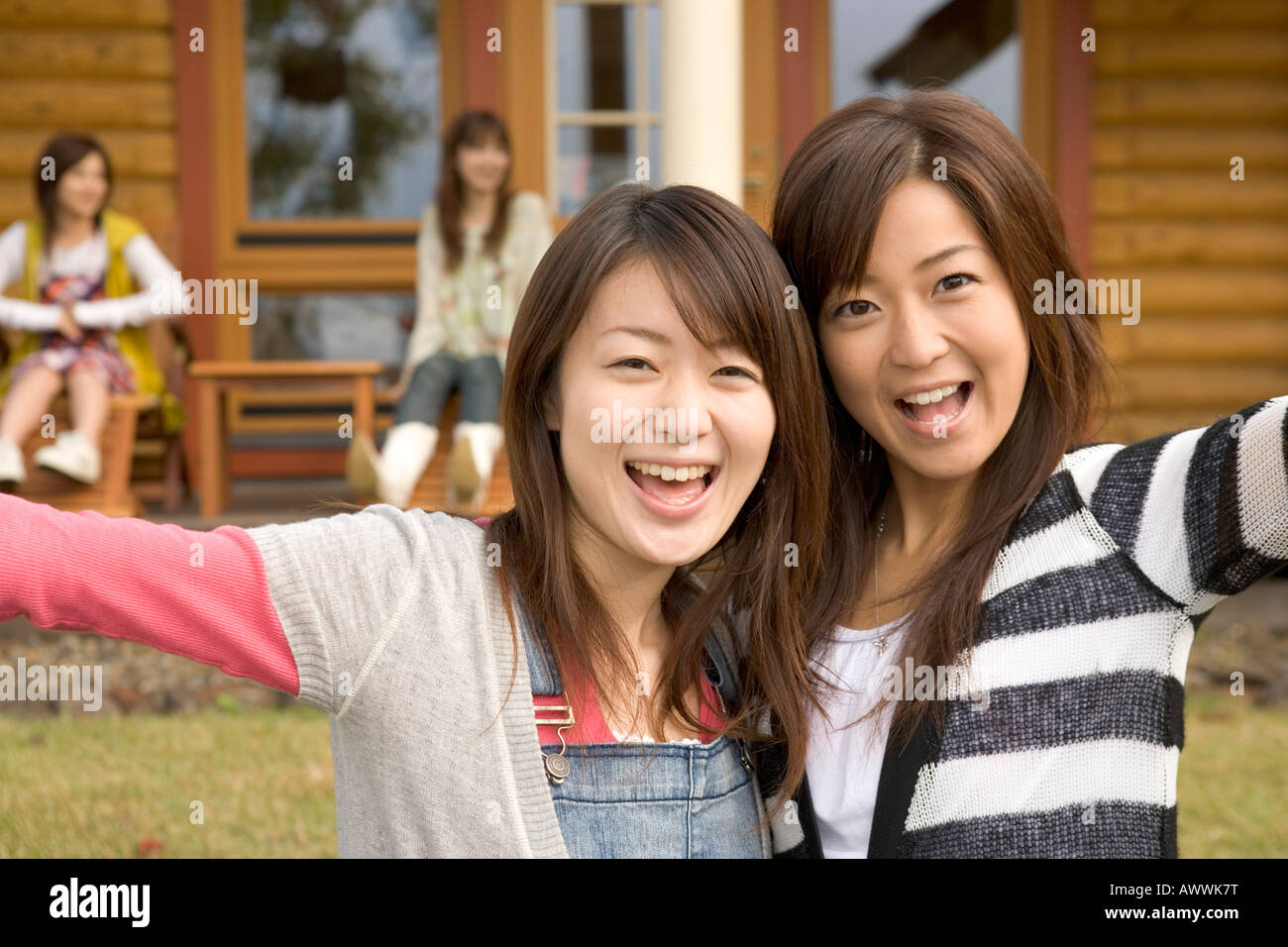 Portrait of two young women outside house Stock Photo - Alamy