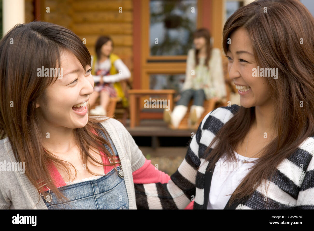 Young women outside house Stock Photo - Alamy