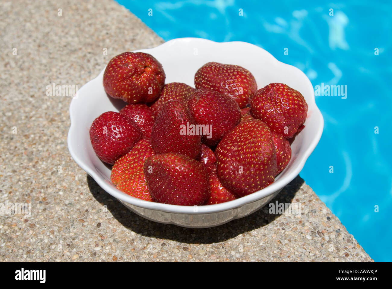 Bowl of Strawberries by Swimming Pool Stock Photo - Alamy