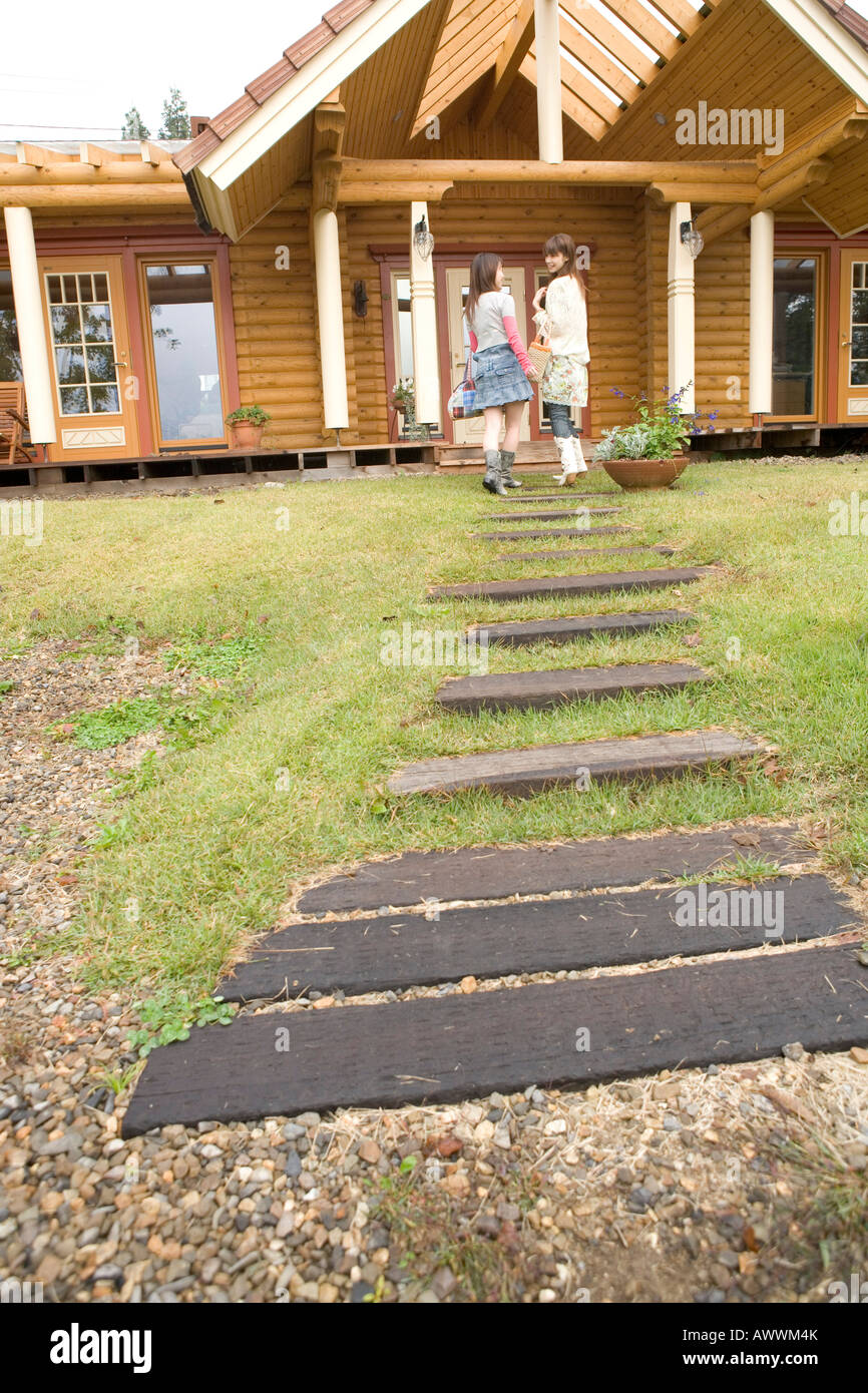 Two women outside house Stock Photo - Alamy