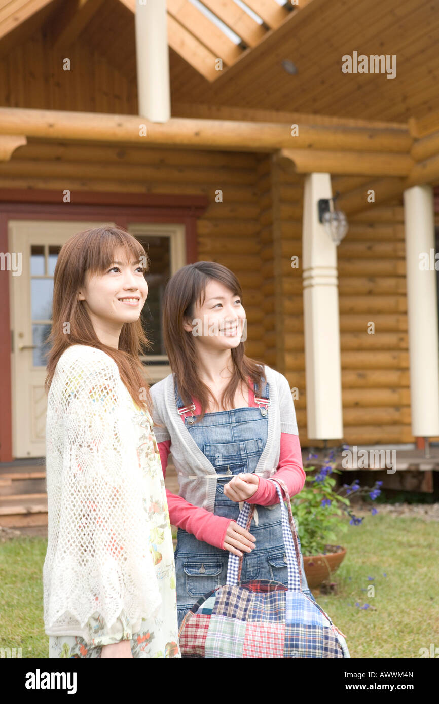 Two women outside house Stock Photo - Alamy
