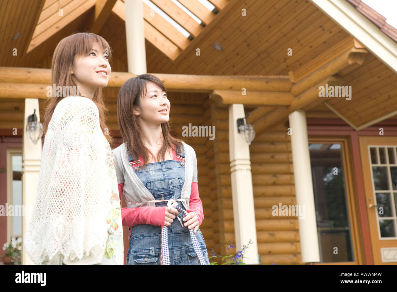 Two women outside house Stock Photo - Alamy