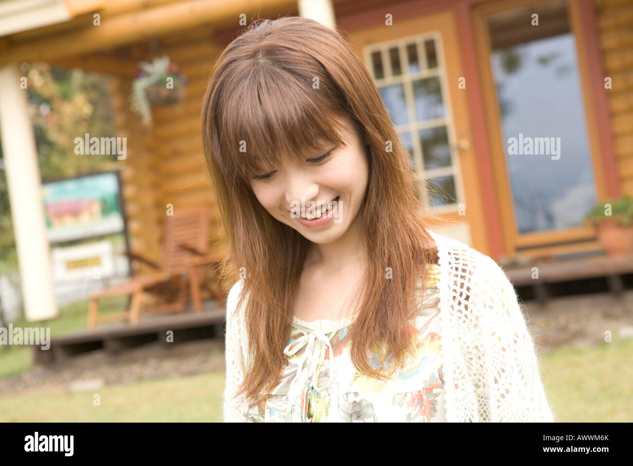 Young woman outside house Stock Photo - Alamy