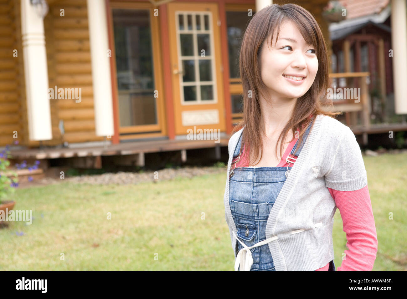 Young woman outside house Stock Photo - Alamy