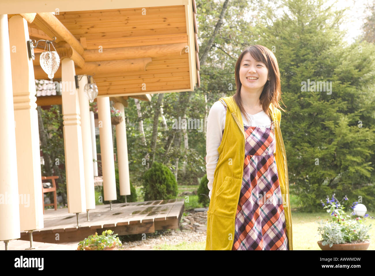 Young woman outside house Stock Photo - Alamy
