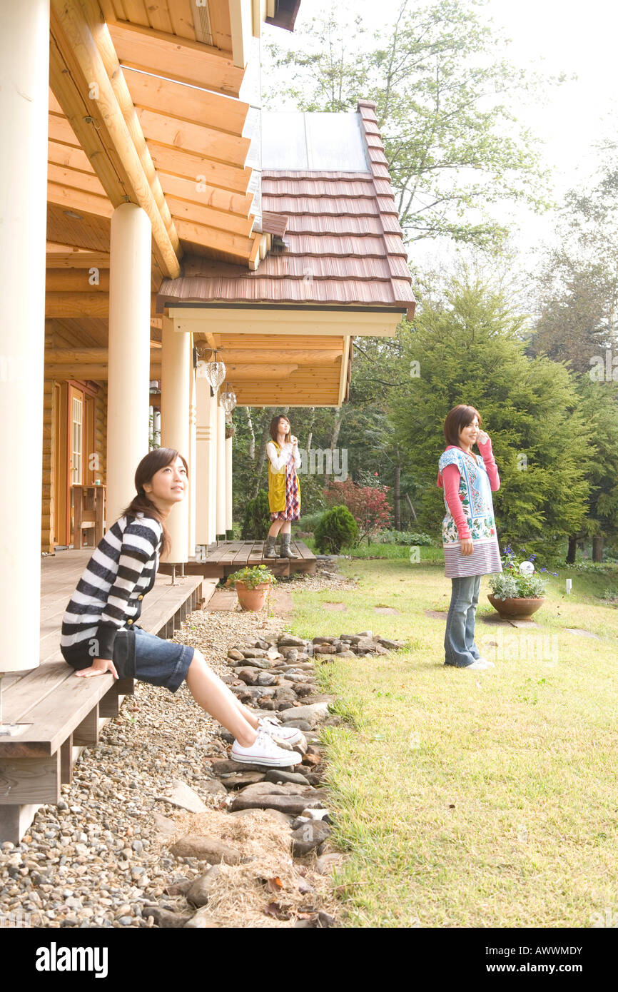 Young women outside house Stock Photo - Alamy