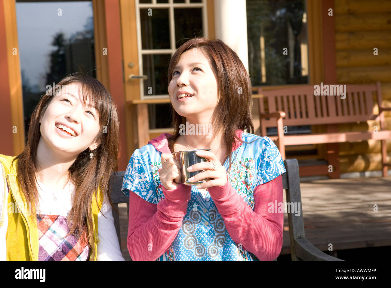 Two young women on porch Stock Photo - Alamy