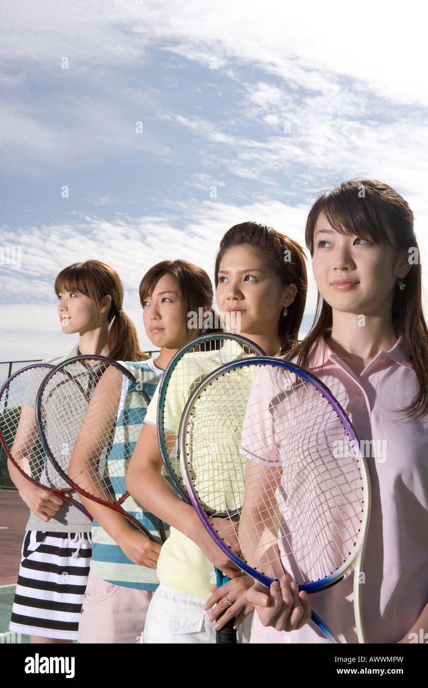 Four young women with tennis rackets Stock Photo - Alamy