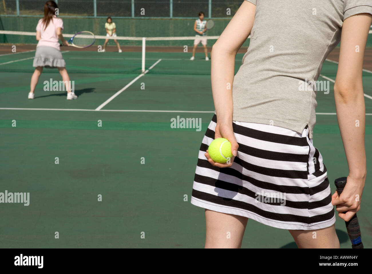 Young women playing tennis on outdoor court Stock Photo - Alamy