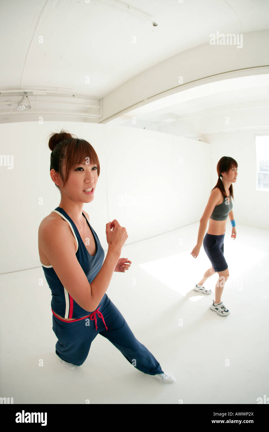 Two young women exercising indoors Stock Photo - Alamy