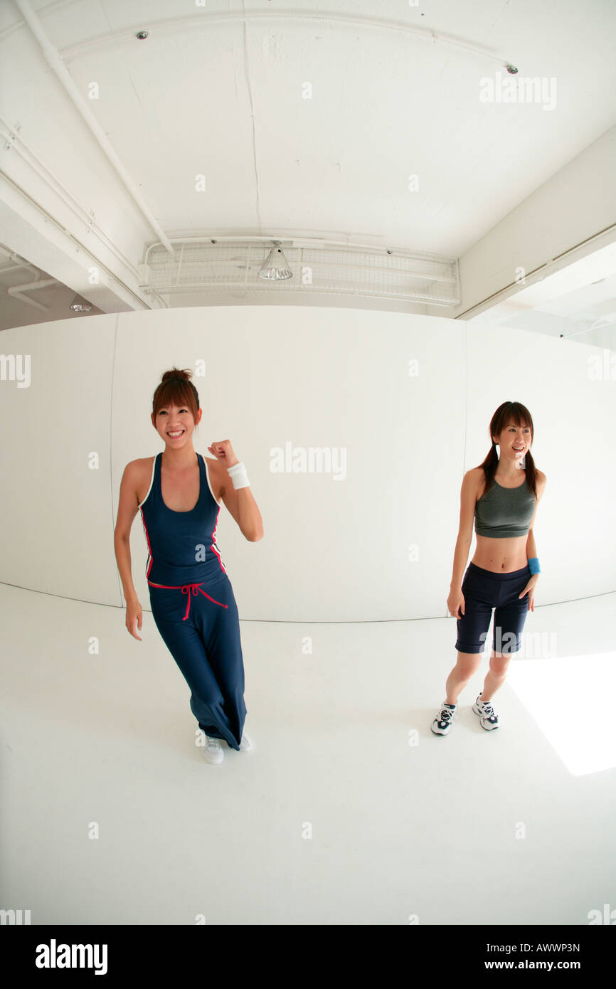 Two young women exercising indoors Stock Photo - Alamy