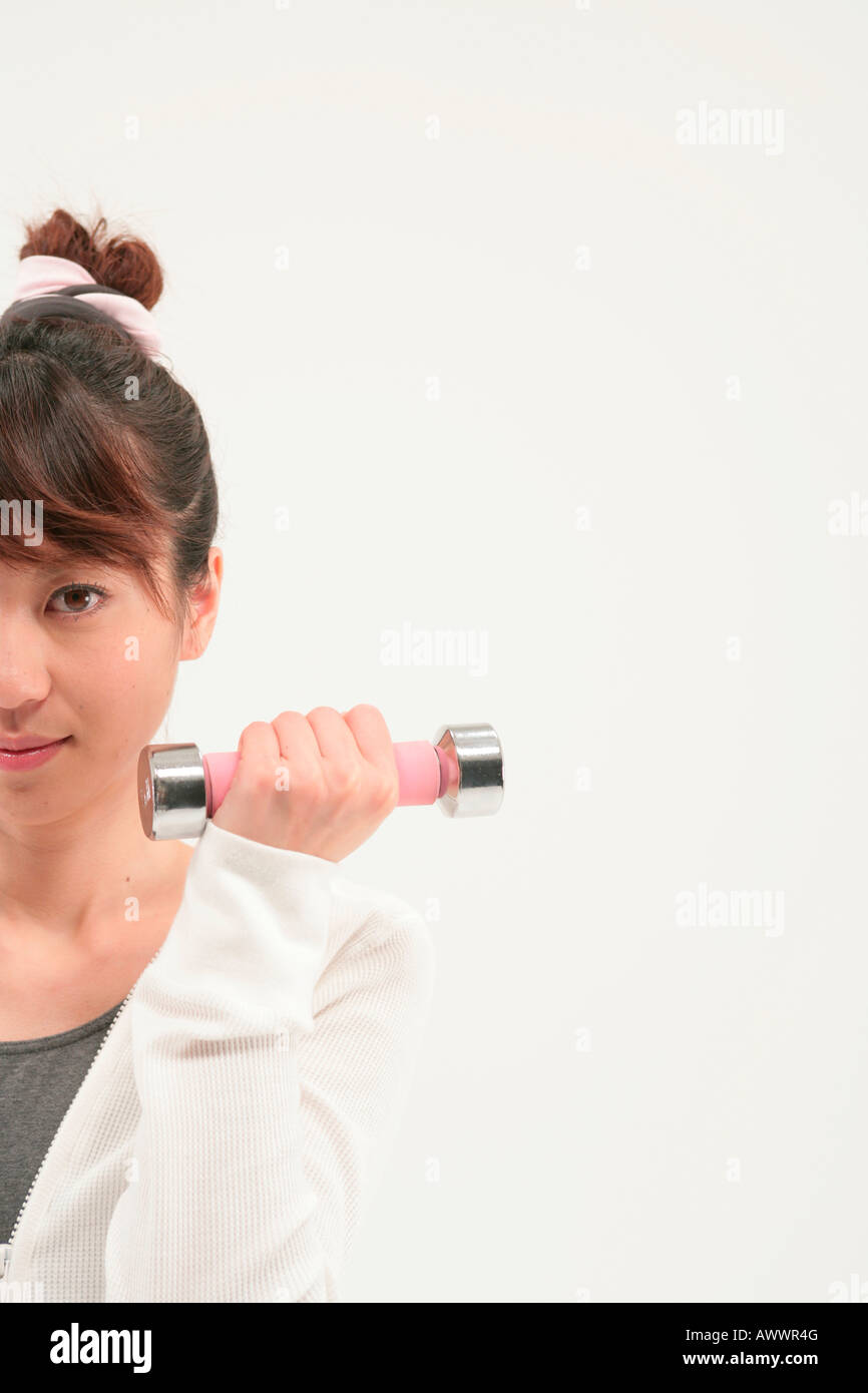 Studio portrait of woman exercising using hand weights Stock Photo - Alamy