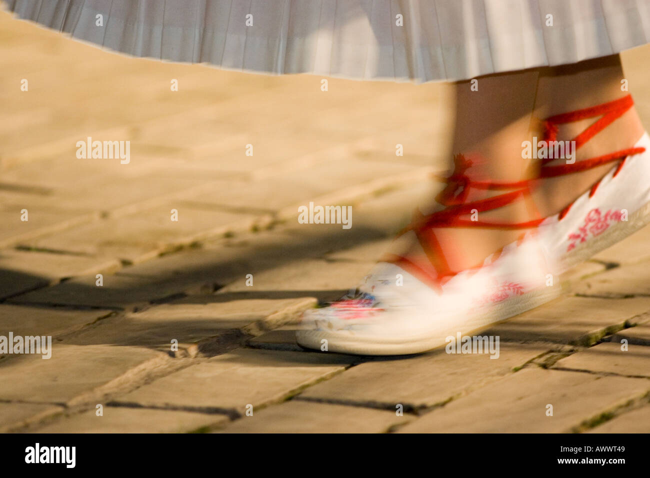 Close up of the shoes and dress of a female Basque traditional dancer ...