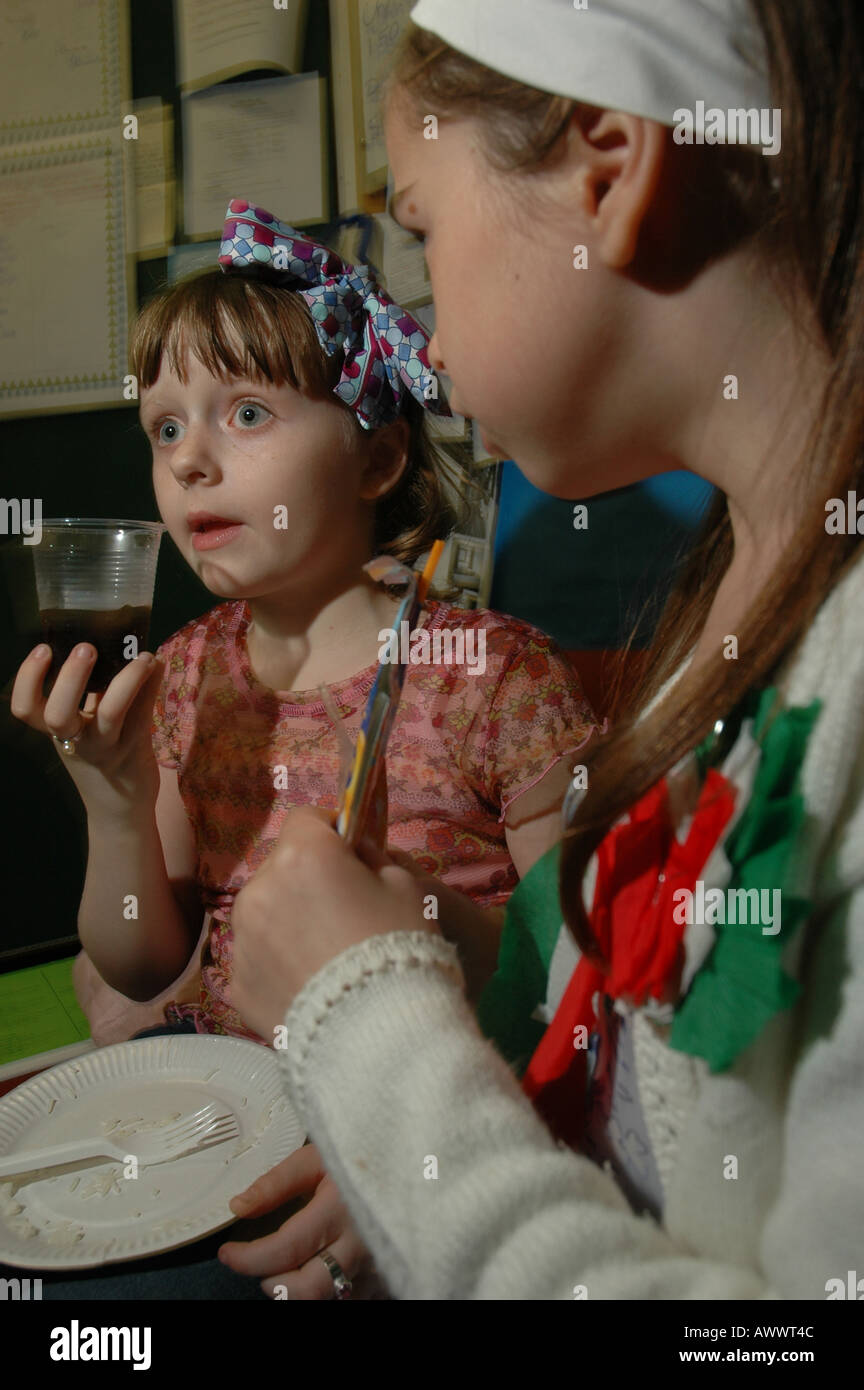 Children in traditional Polish costume eating and drinking Stock Photo ...