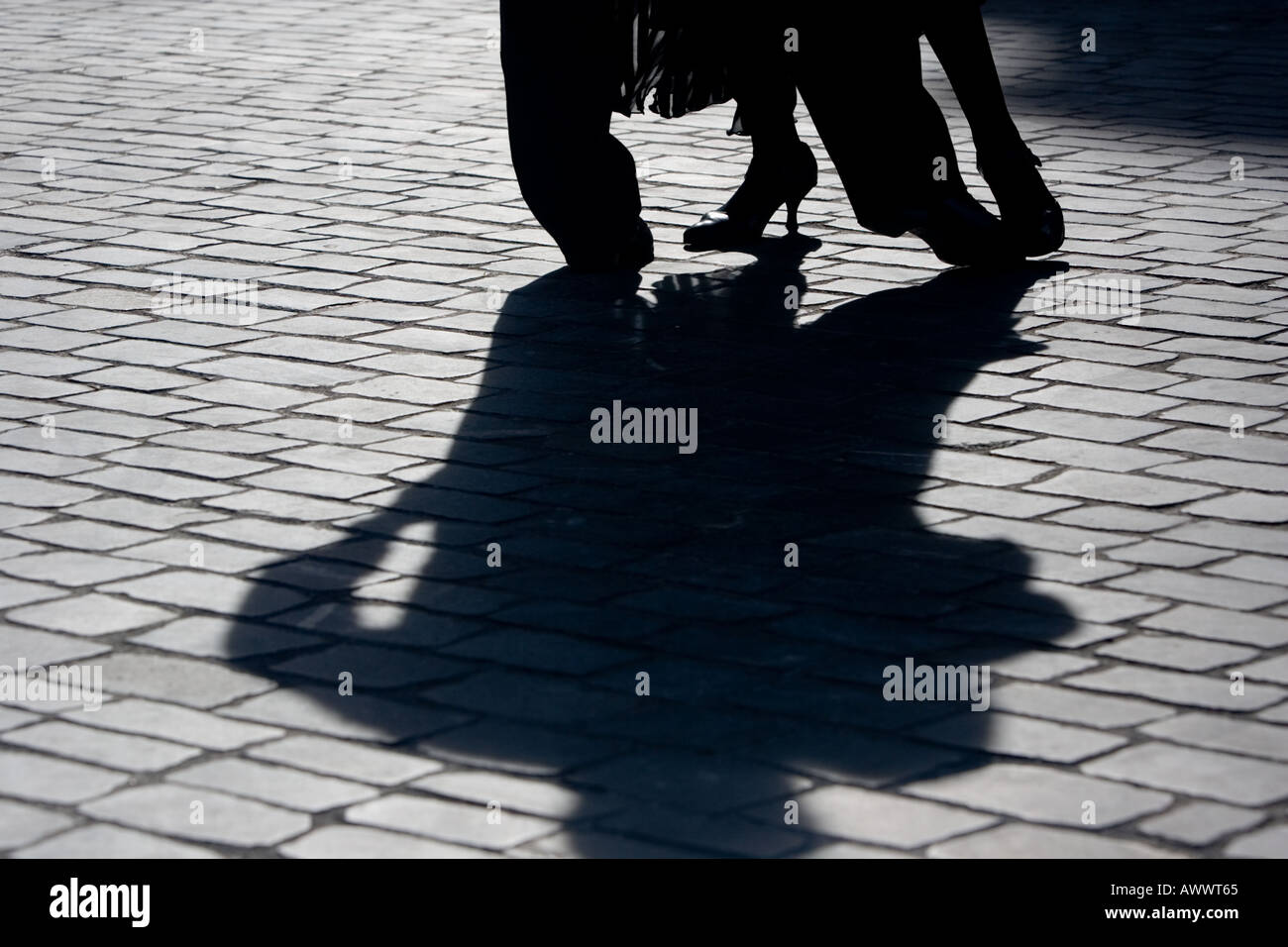 Shadows of two Spanish dancers merge into one as they dance the tango ...