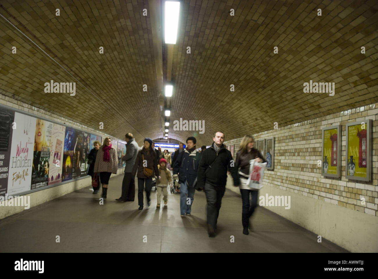 Commuters walk through an underground walkway near the South Kensington ...