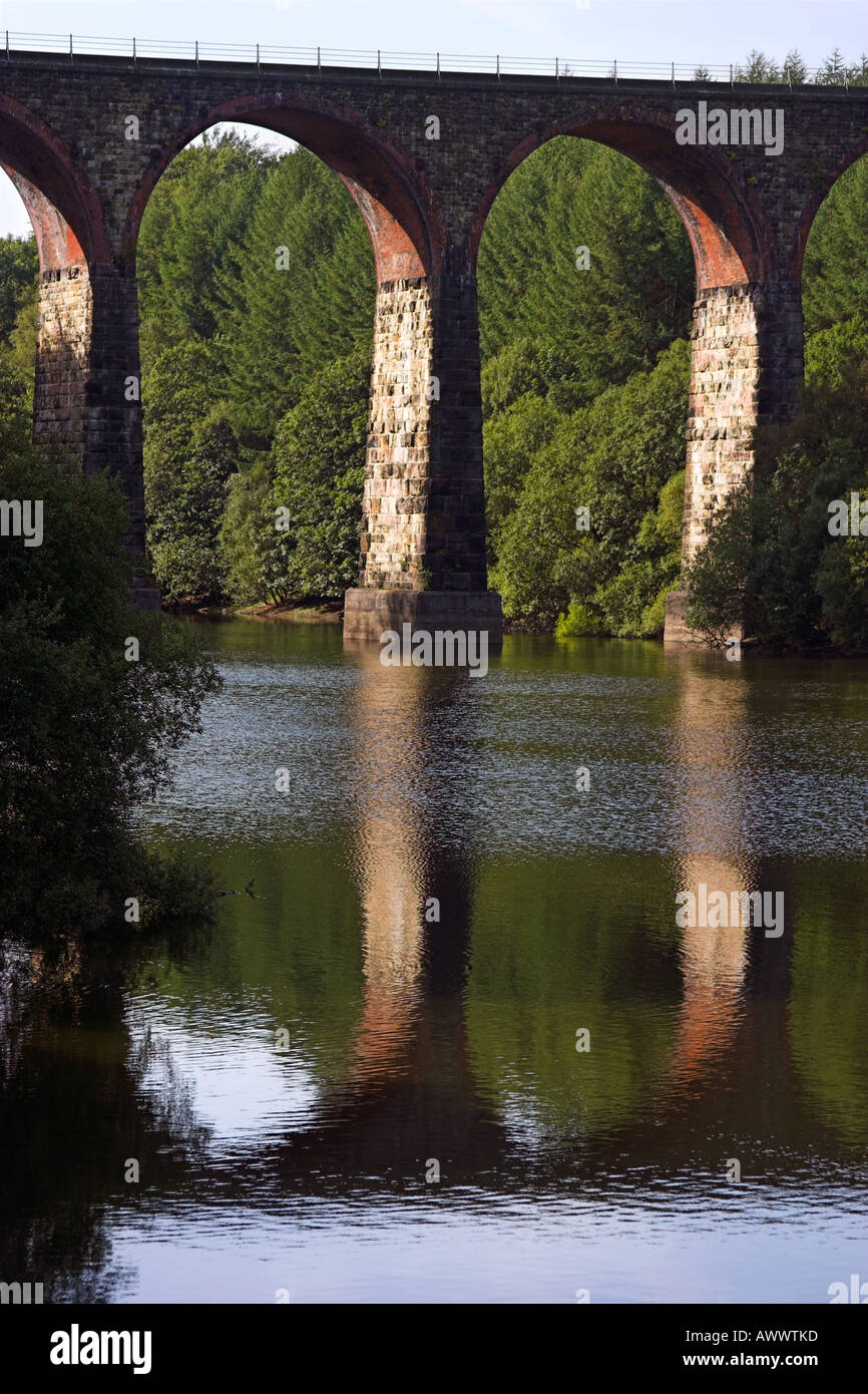 Railway viaduct reflected in the waters of Wayoh reservoir near ...