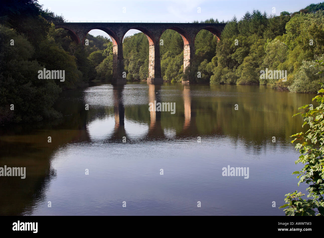 Railway viaduct reflected in the waters of Wayoh reservoir near ...