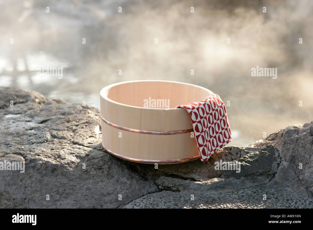 Wooden bucket on rock in japanese spa Stock Photo - Alamy