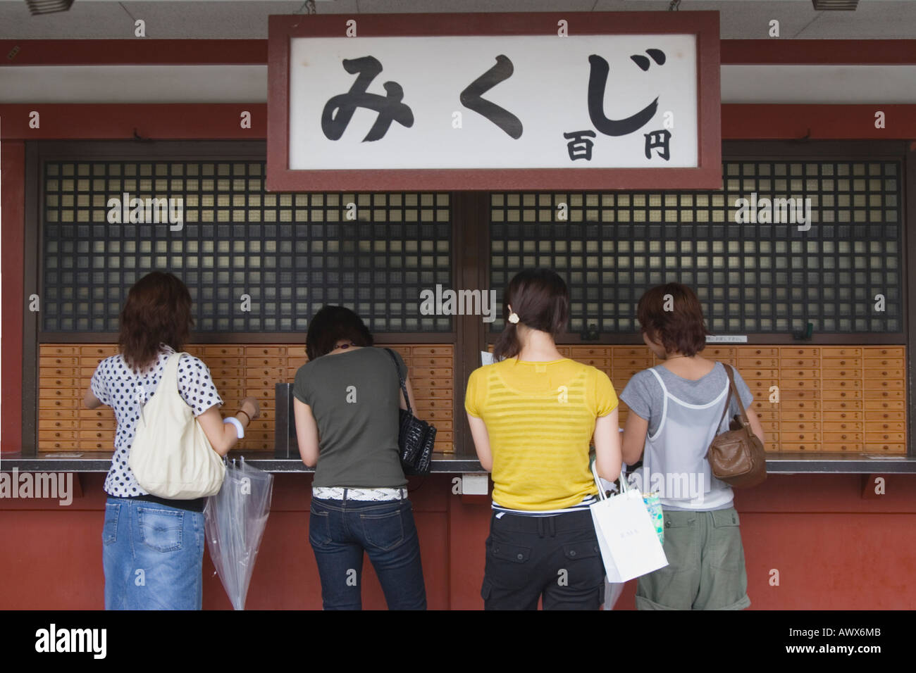 A group of women visitors getting their omikuji fortune at Sensoji Temple, Asakusa Kannon Temple ...
