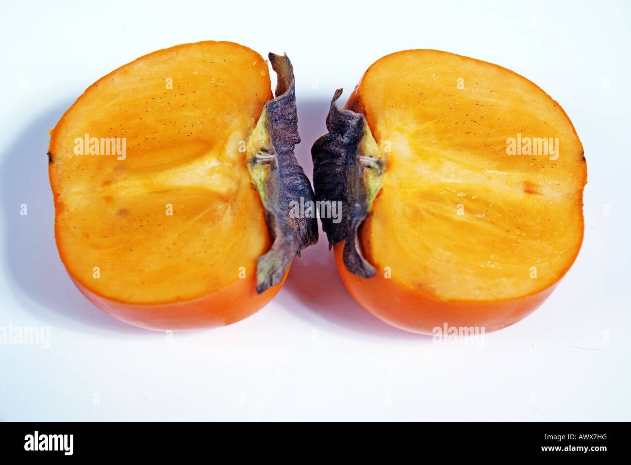 Kaki cut in halfes Stock Photo - Alamy