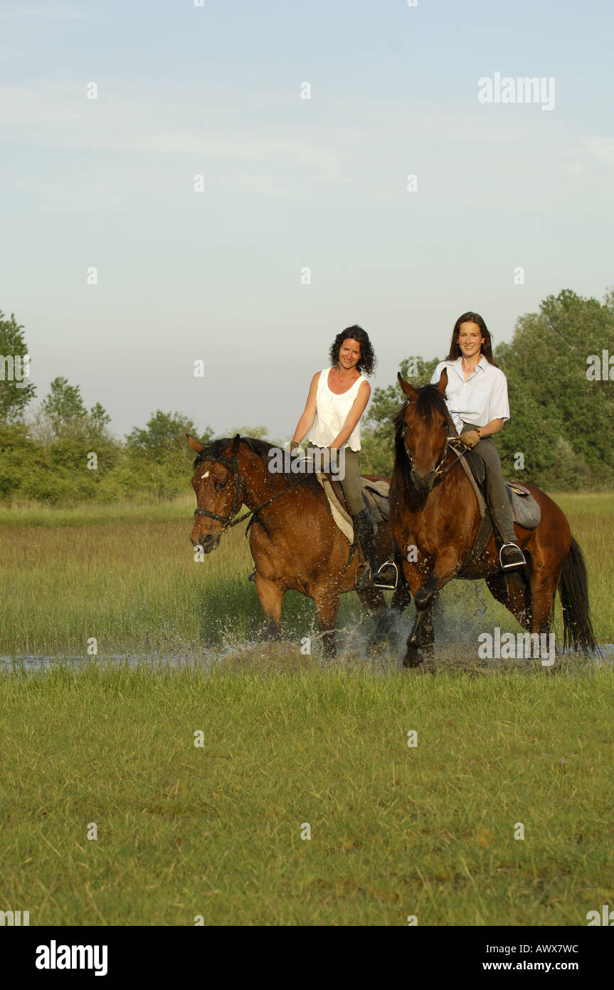 Young women riding horses in hi-res stock photography and images - Alamy