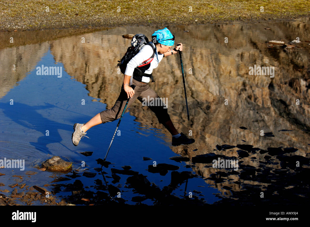 hiker crossing of a shallow water Stock Photo - Alamy