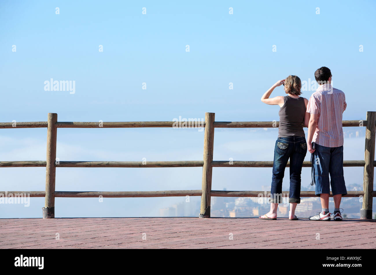Couple looking over fence hi-res stock photography and images - Alamy