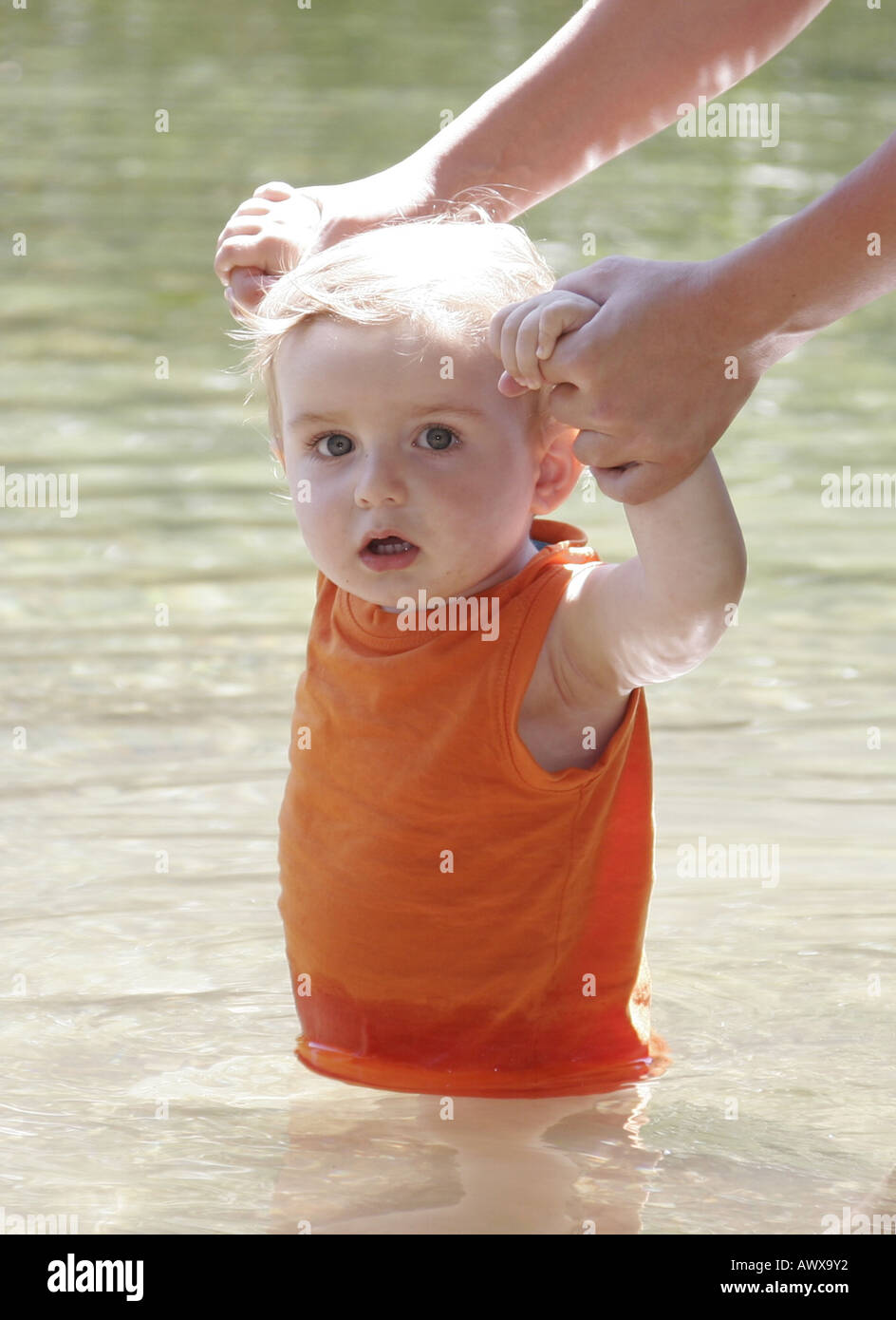 small boy wading through shallow water Stock Photo - Alamy