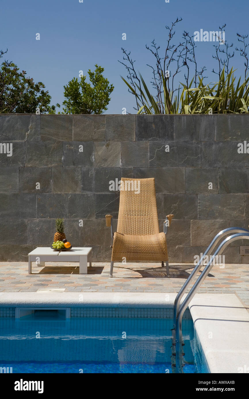 Empty chair beside swimming pool Stock Photo - Alamy
