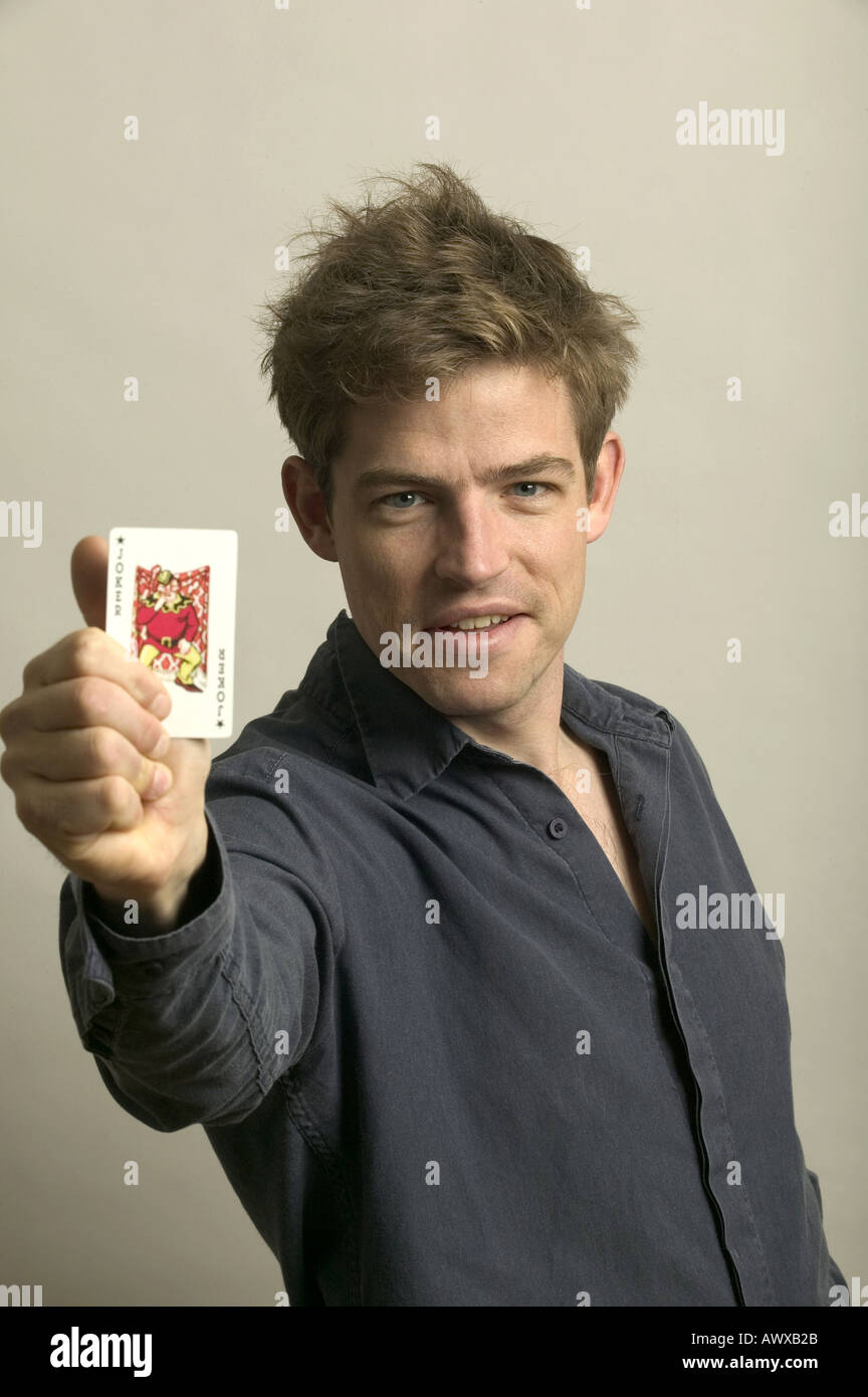 Young man showing Poker cards Stock Photo - Alamy