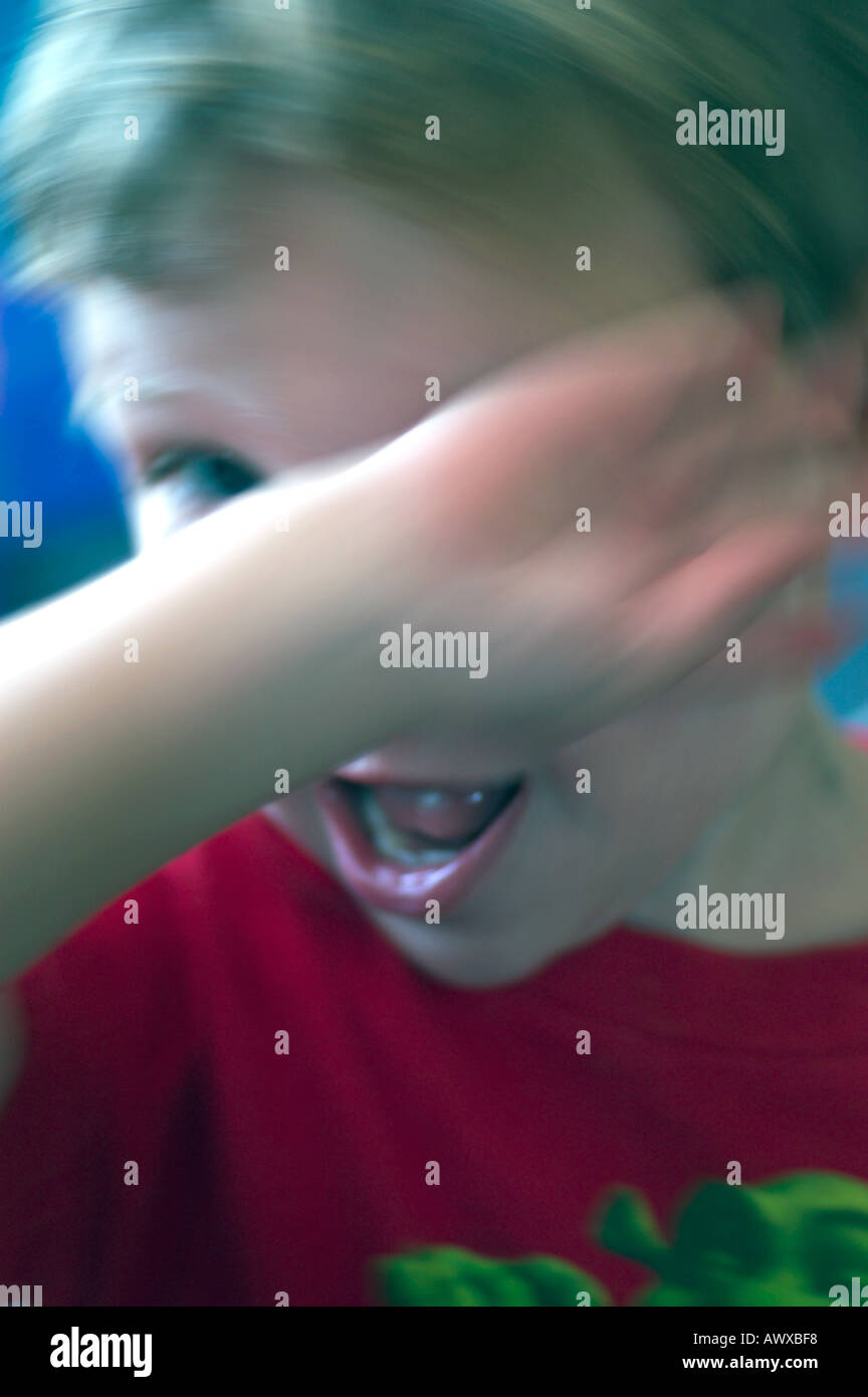 boy hiding behind hand Stock Photo - Alamy