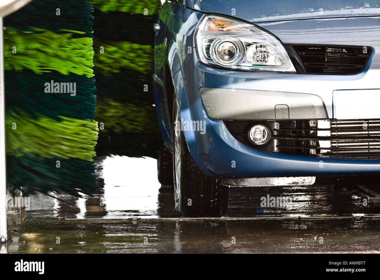 Blue car during washing process Stock Photo - Alamy