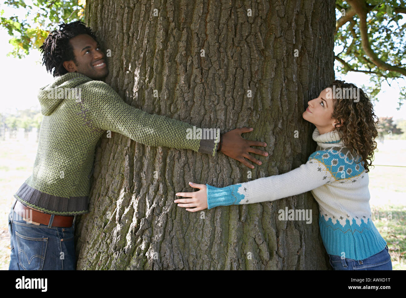 Couple hugging tree Stock Photo - Alamy