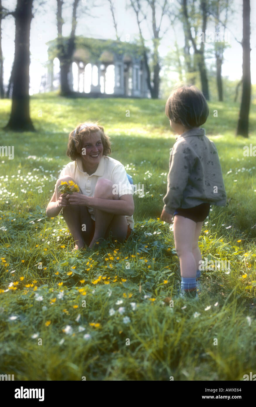 MOTHER AND SON PICKING FLOWERS Stock Photo - Alamy