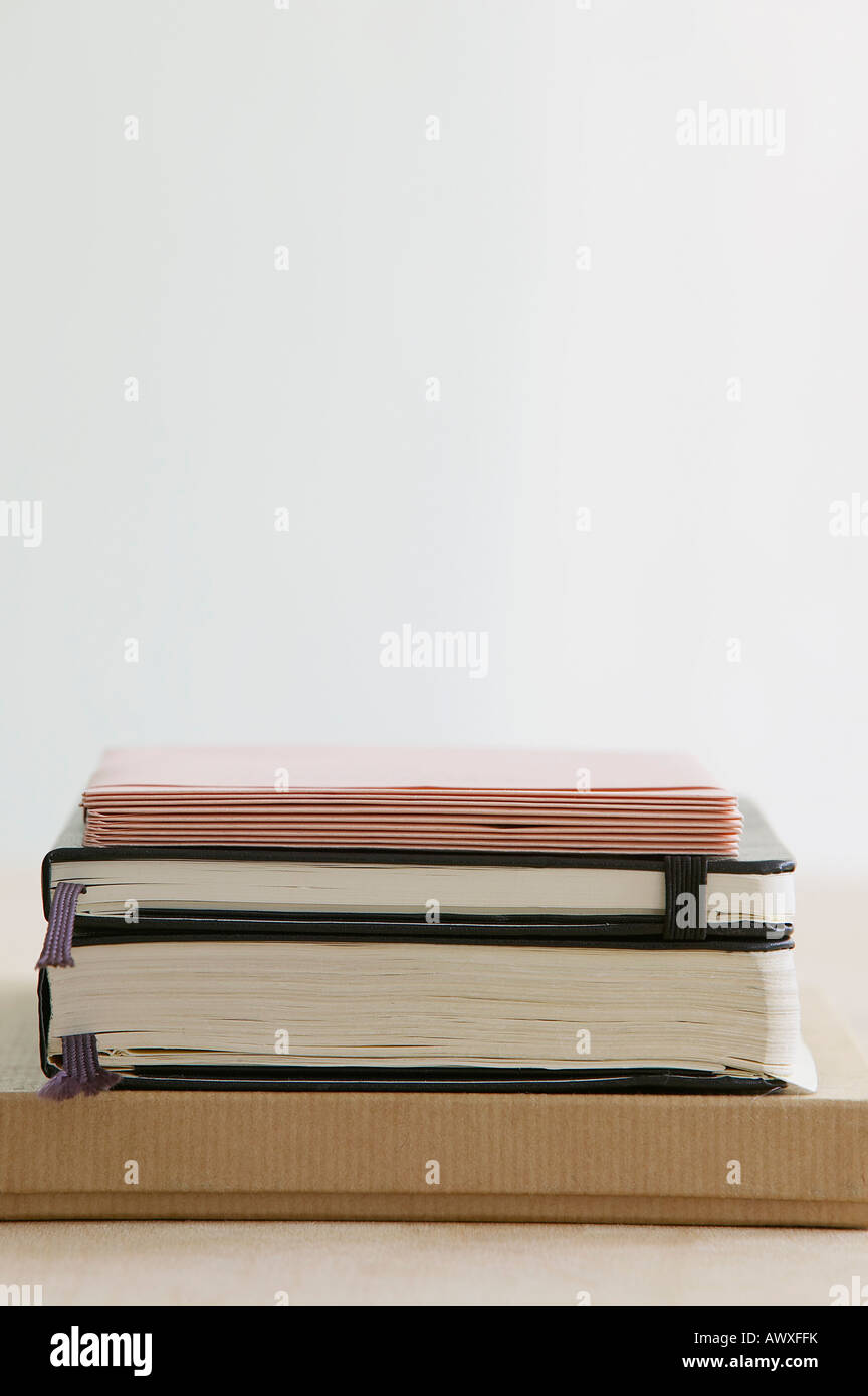 Stack of books and paper stationery, studio shot Stock Photo - Alamy