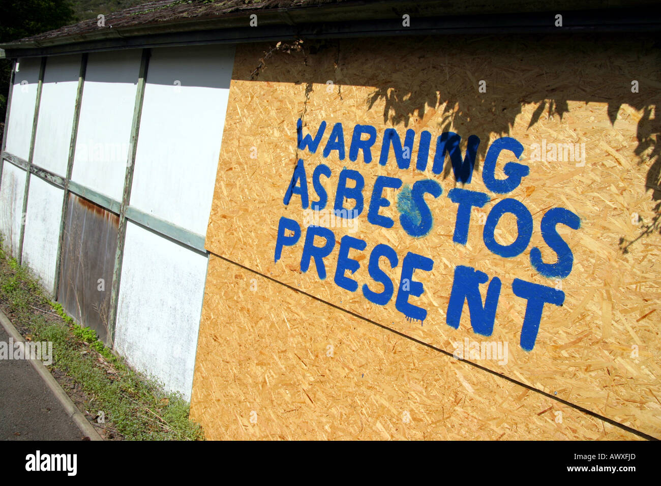 old building containing asbestos with warning sign saying such Stock ...