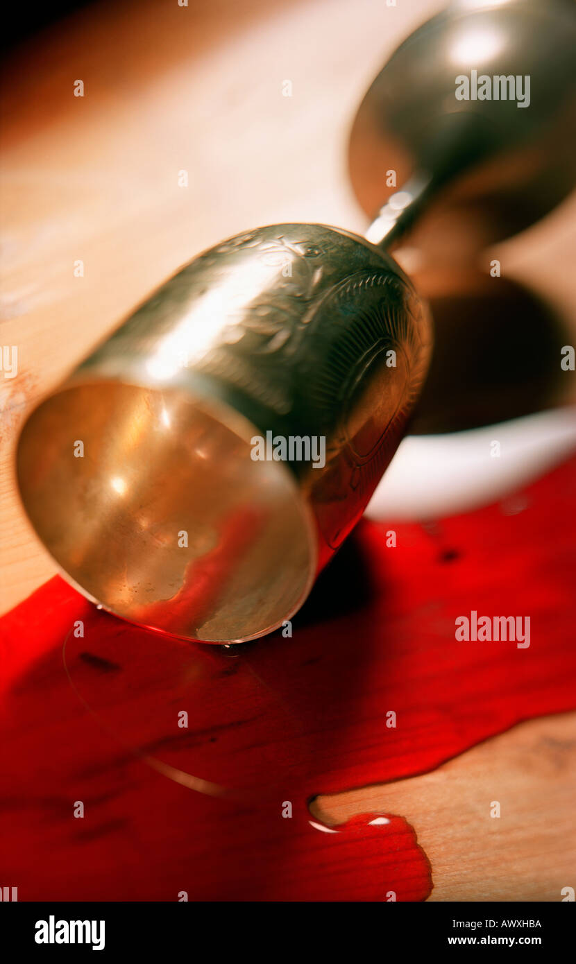 fallen chalice spilling red wine Stock Photo - Alamy