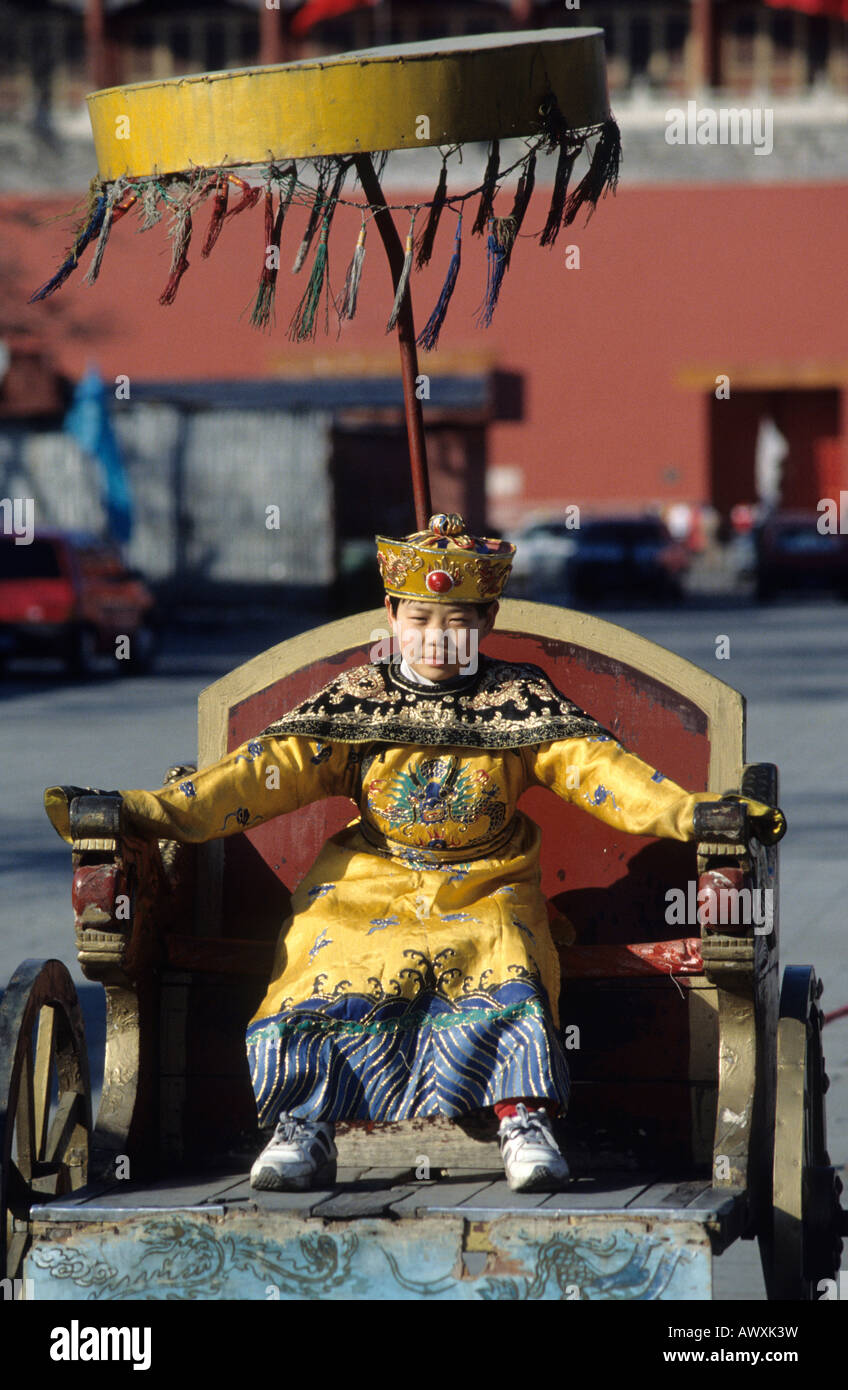 A boy dressed like an Emperor for a photo in Forbidden City in Beijing ...