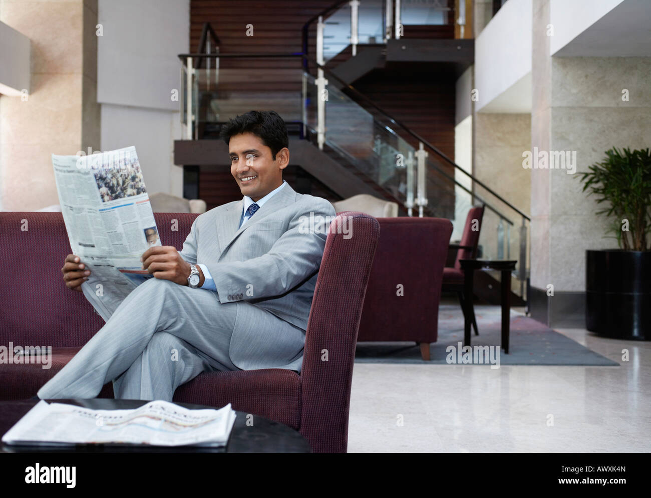 Business man reading newspaper, smiling Stock Photo - Alamy