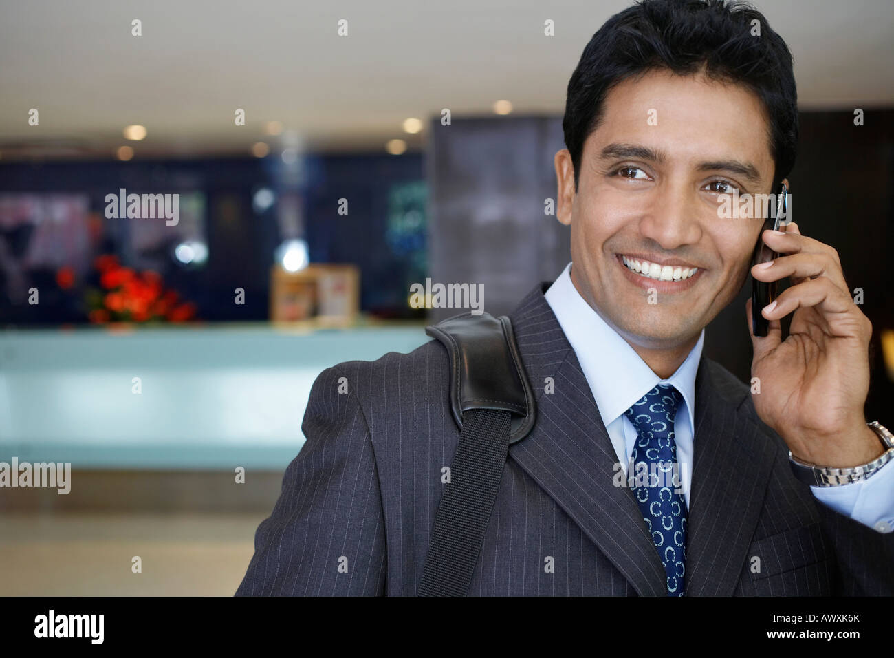 Business man using mobile phone in hotel lobby Stock Photo - Alamy