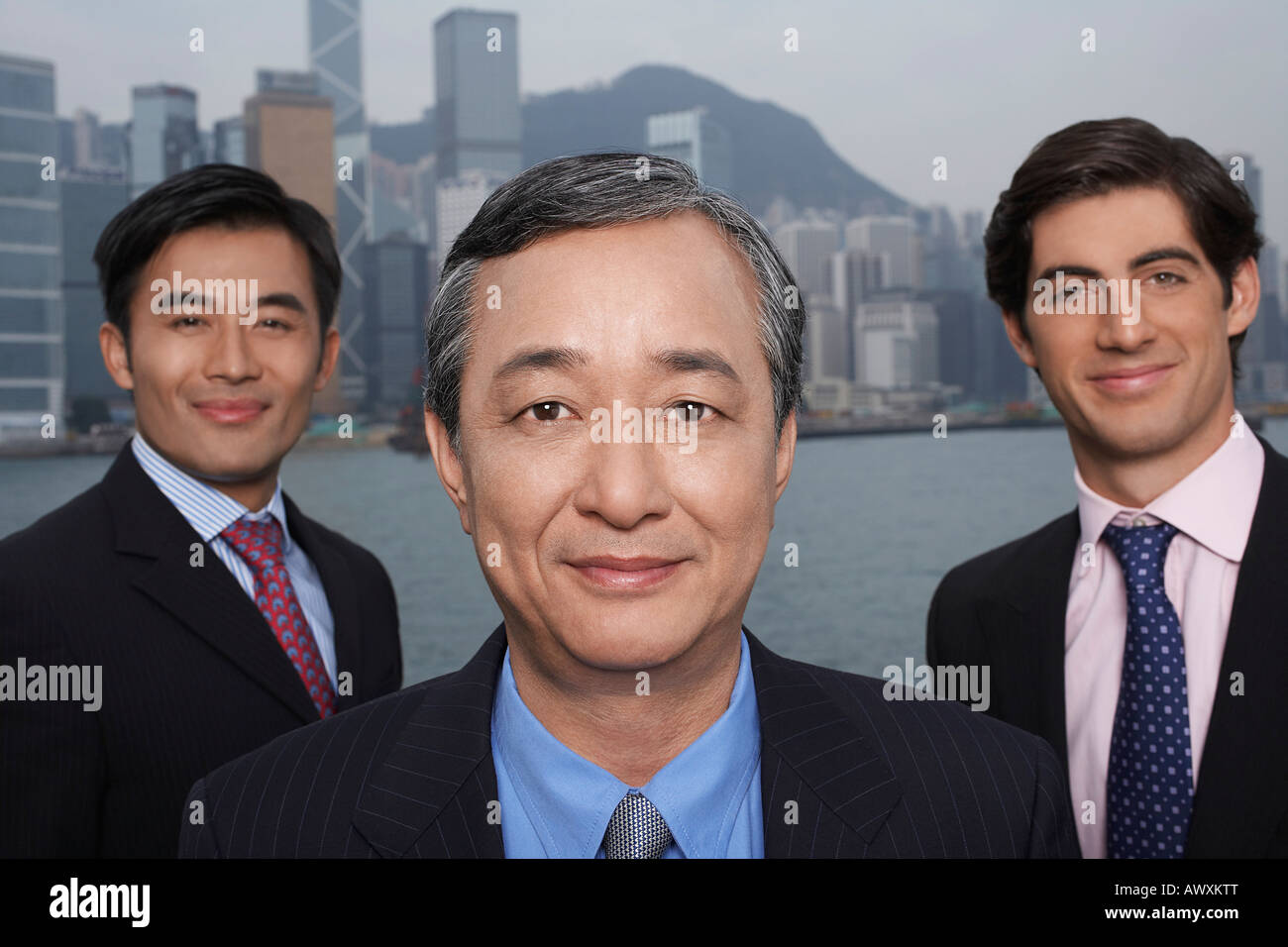 Portrait of three business men, office buildings in background Stock ...