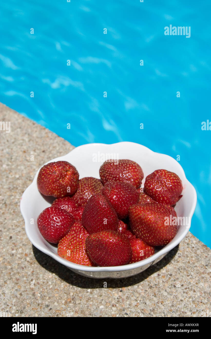 Bowl of Strawberries by Swimming Pool Stock Photo - Alamy