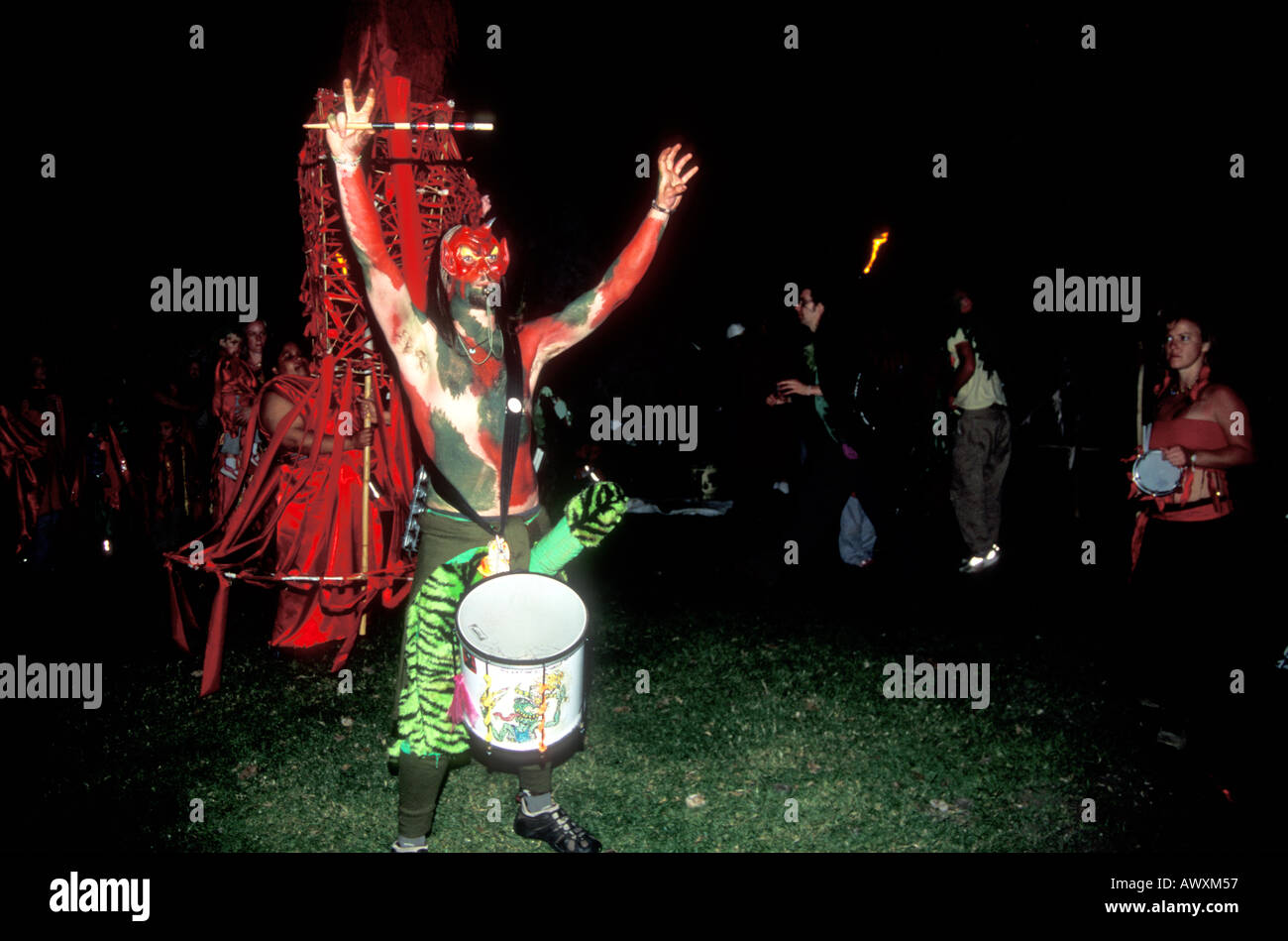 Pagan man in costume playing the drums at Avebury stone circle during ...