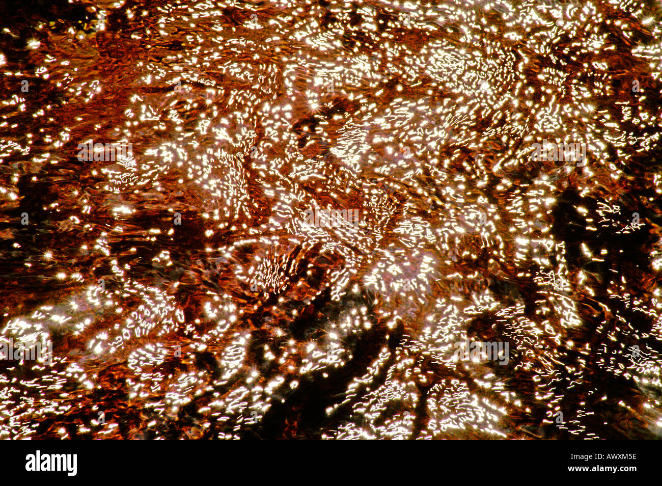 Red orange coloured Light Sun reflection on Water Surface Stock Photo ...