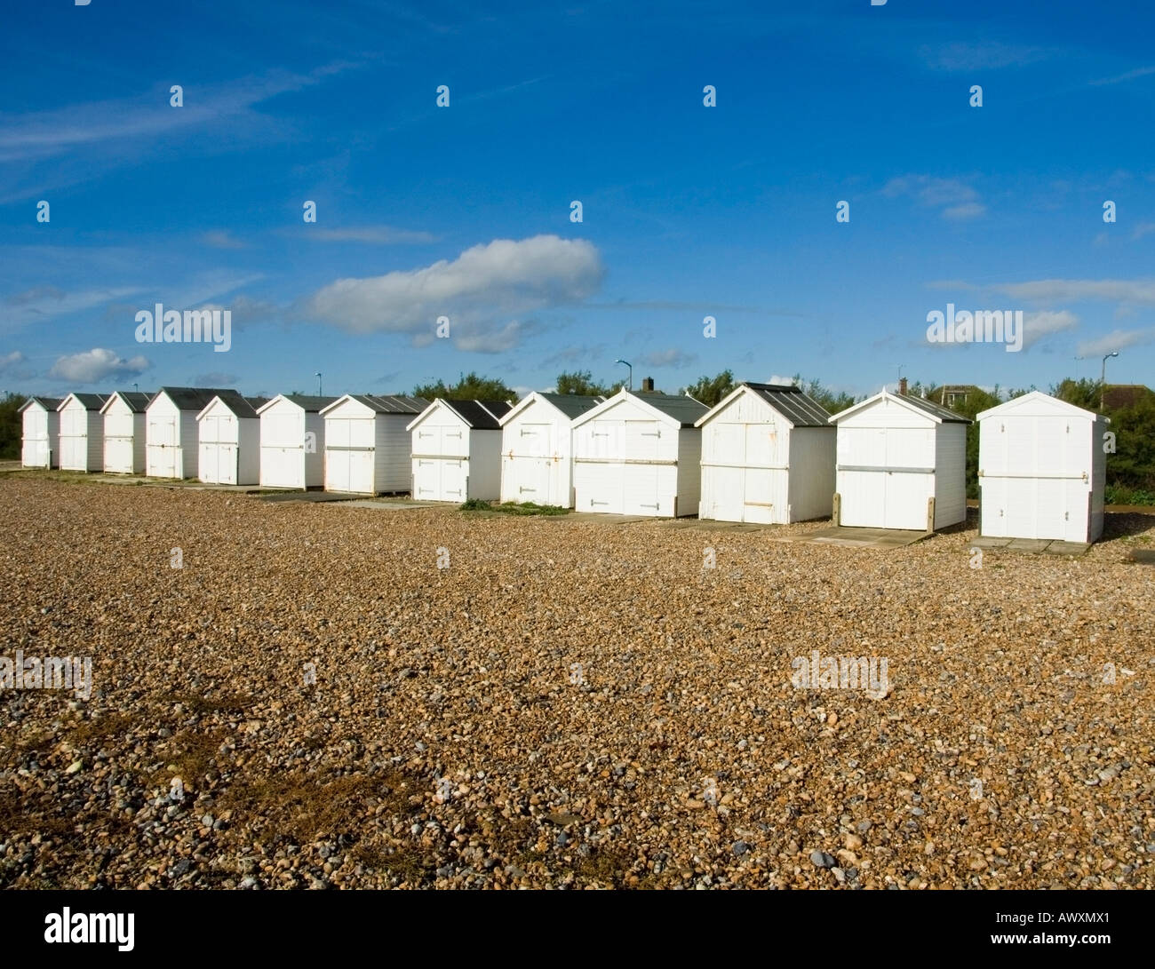 Right side view of beach huts with the blue sky and pebble beach in the ...